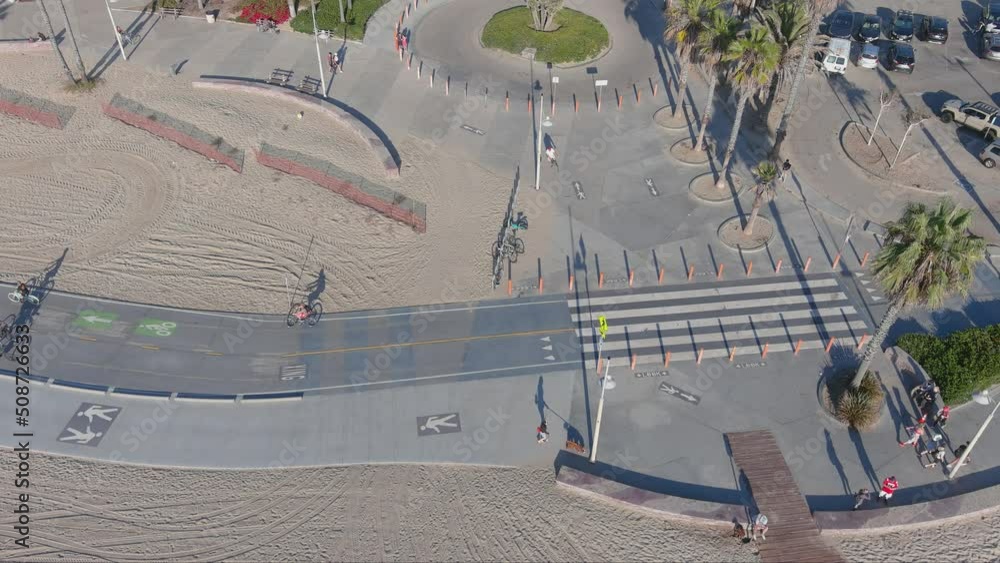 aerial footage of people walking and riding bikes on a smooth bike path ...