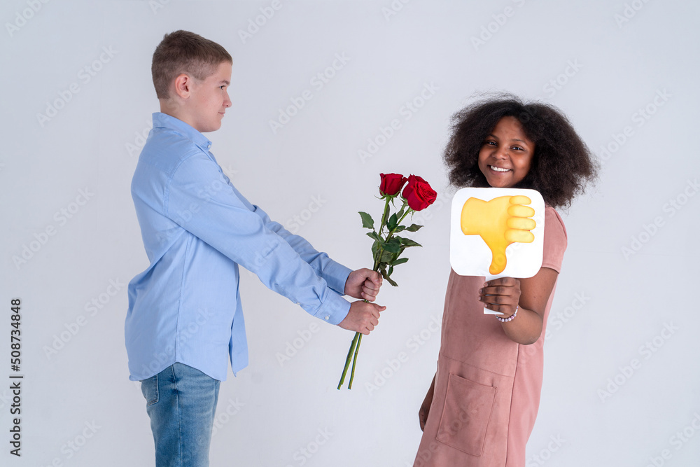 Teen boy gives his girlfriend a bouquet of red roses and girl shows ...