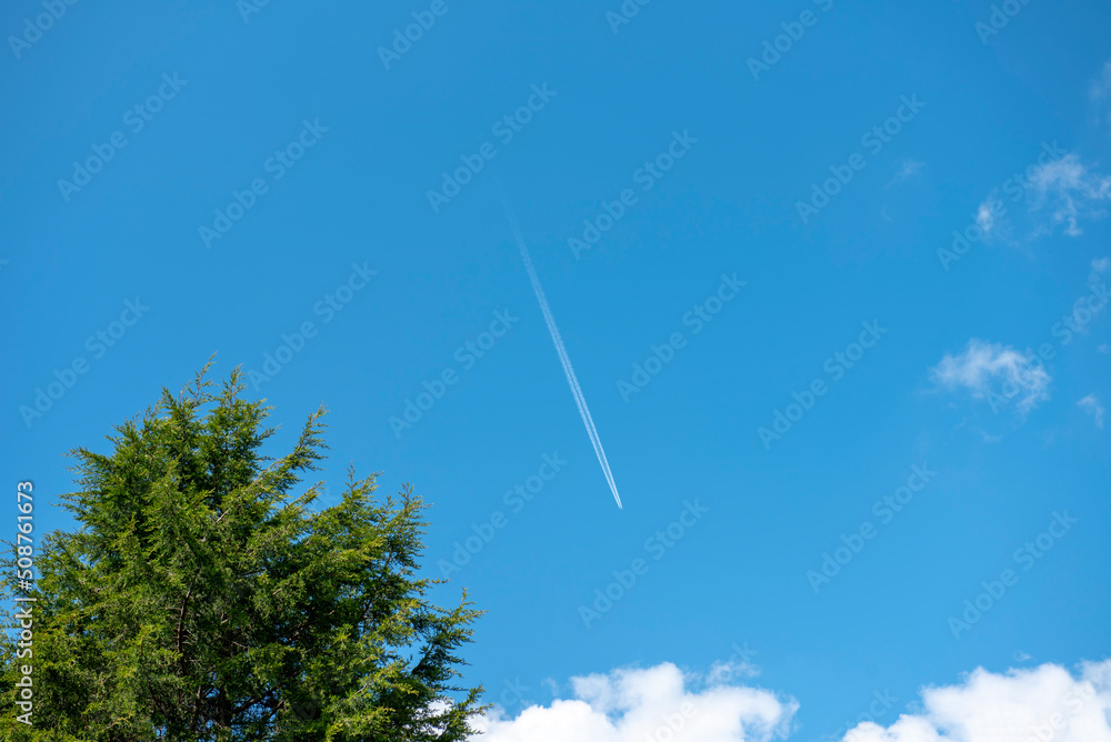 Background image of a plan trail, contrails in a blue sky with white ...