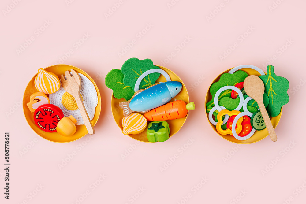 Plates with breakfast, lunch and dinner. Wooden fruit and vegetables ...