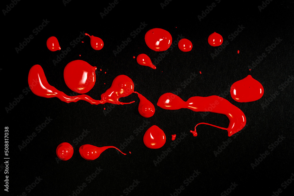 Red ink spots on black background. .Red paint spots look like blood ...