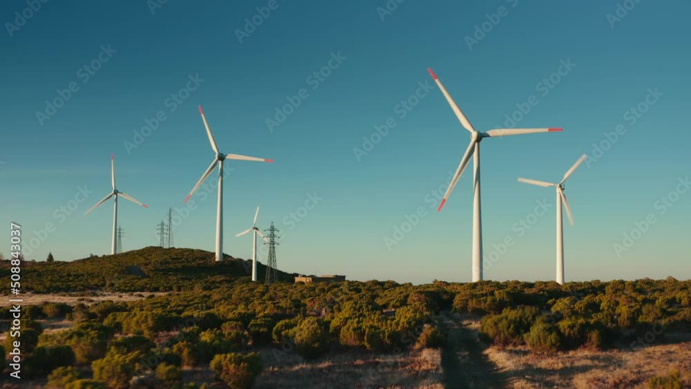 rotation wind turbine wind mills on the hill blue sky background green ...
