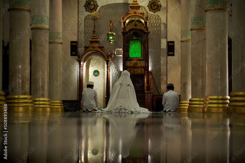 Muslim women praying for the blessings of Allah At the mosque in ...