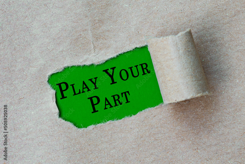 Play your part text on torn hole in the sheet of brown paper on green ...