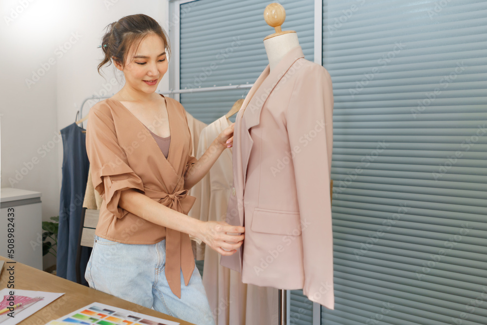 Fashion design concept, Asian female tailor is checking quality ...