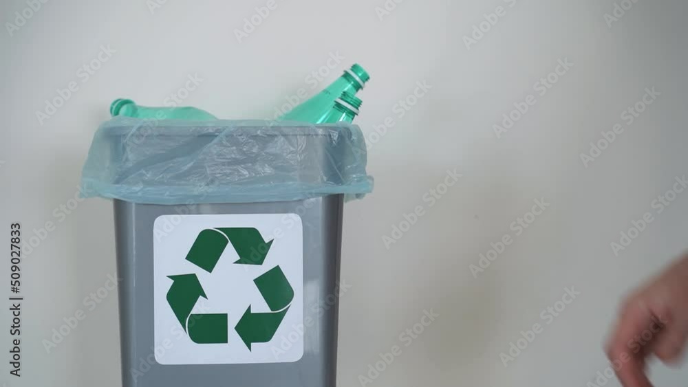 Male hand getting plastic bottles to dispose in garbage box ready to ...