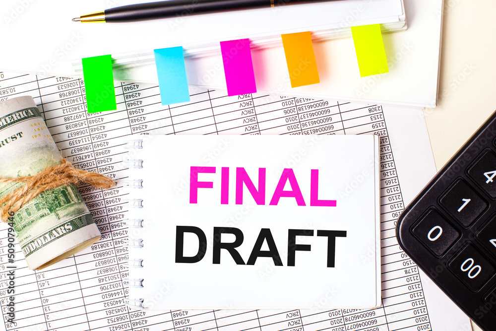 On a light background, a pen, dollars, a notebook with the text FINAL ...