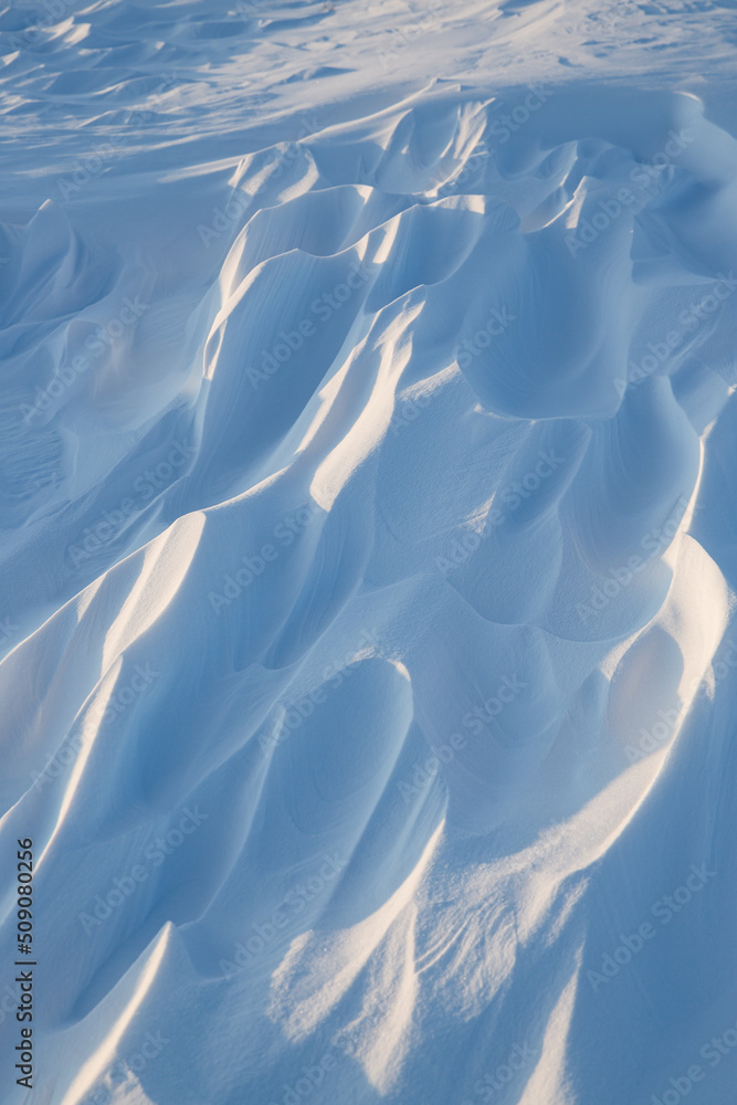 Snow texture. Wind sculpted patterns on snow surface. Wind in the ...