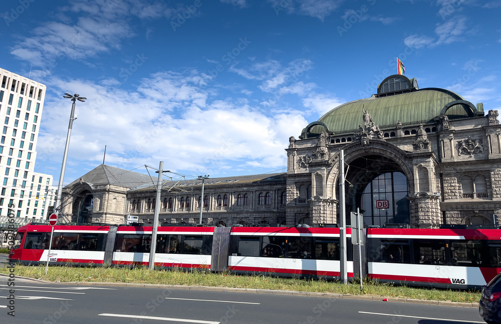 Nuremberg Central Station with a tram in front of it. Public ...