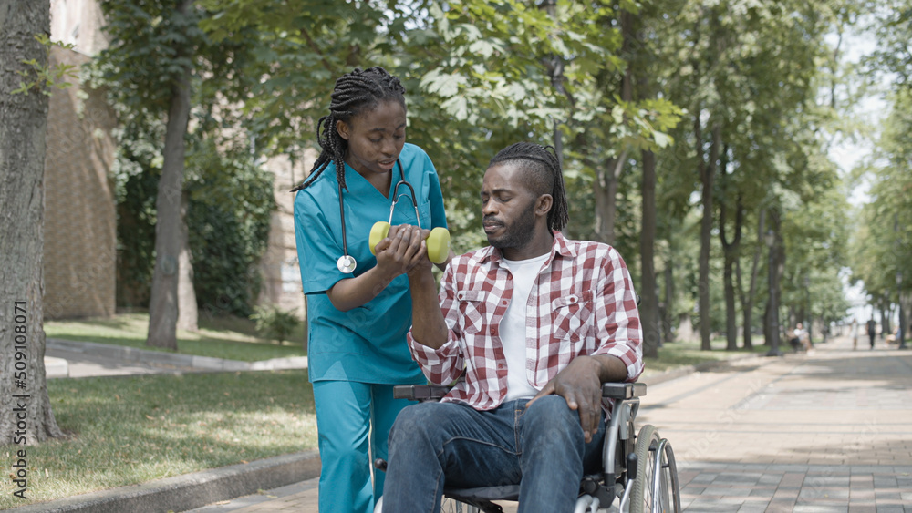 Rehabilitation doctor helping male patient do exercises, recovery after ...