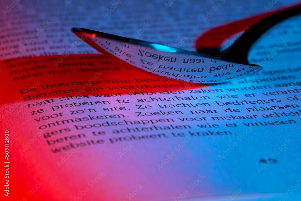 Reflection of printed text on the back of a steel spoon. Text on a ...