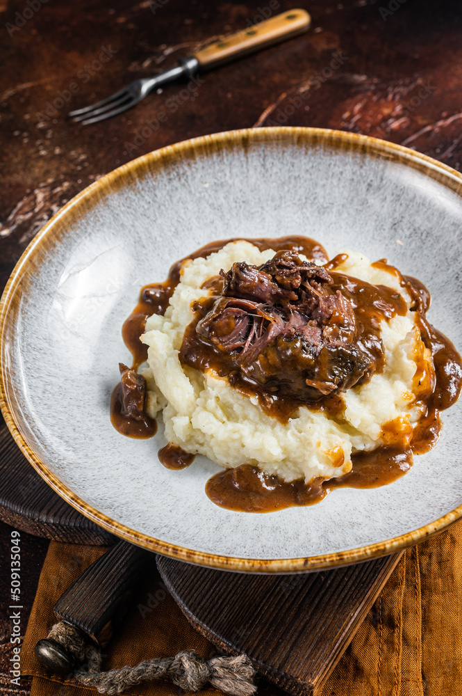 Slow cooked beef cheeks in red wine sauce with mashed potato. Dark ...
