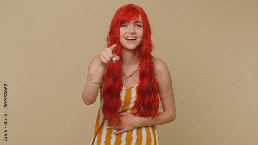 Amused ginger woman in tank top pointing finger to camera, laughing out ...