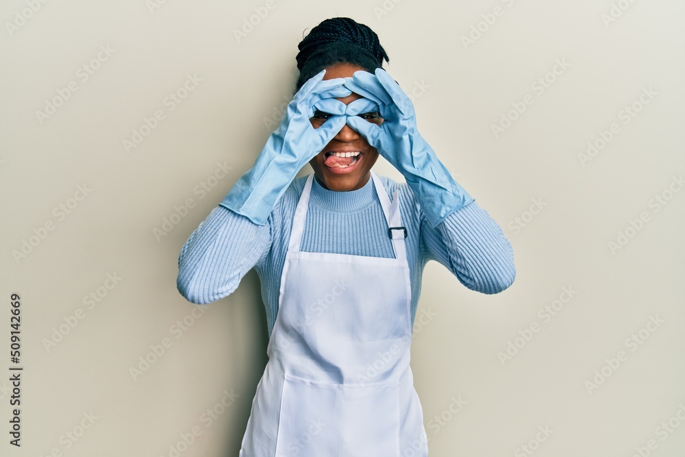 African american woman with braided hair wearing cleaner apron and ...