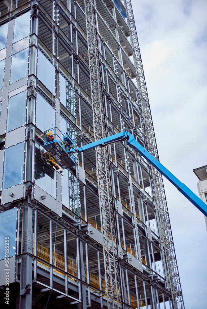 Installation of double-glazed windows from a crane, on a high-rise ...