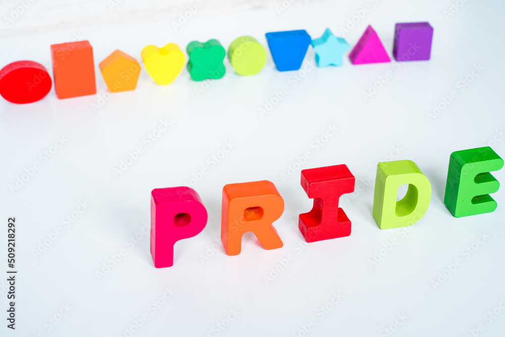 Word pride on an angle in colored block lettering with colored rainbow ...
