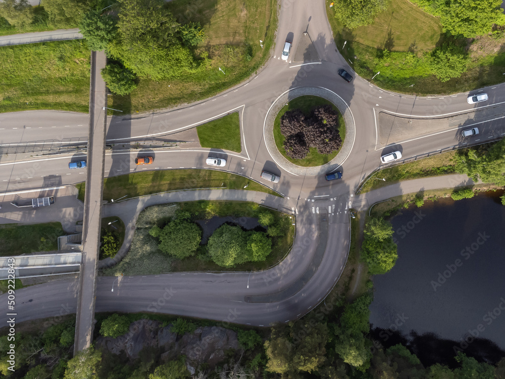 Bird's eye view of a traffic roundabout, roads, lanes with cars and a ...