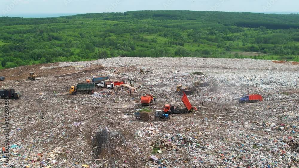 Dump of unsorted waste. Garbage trucks unload garbage at the city dump ...