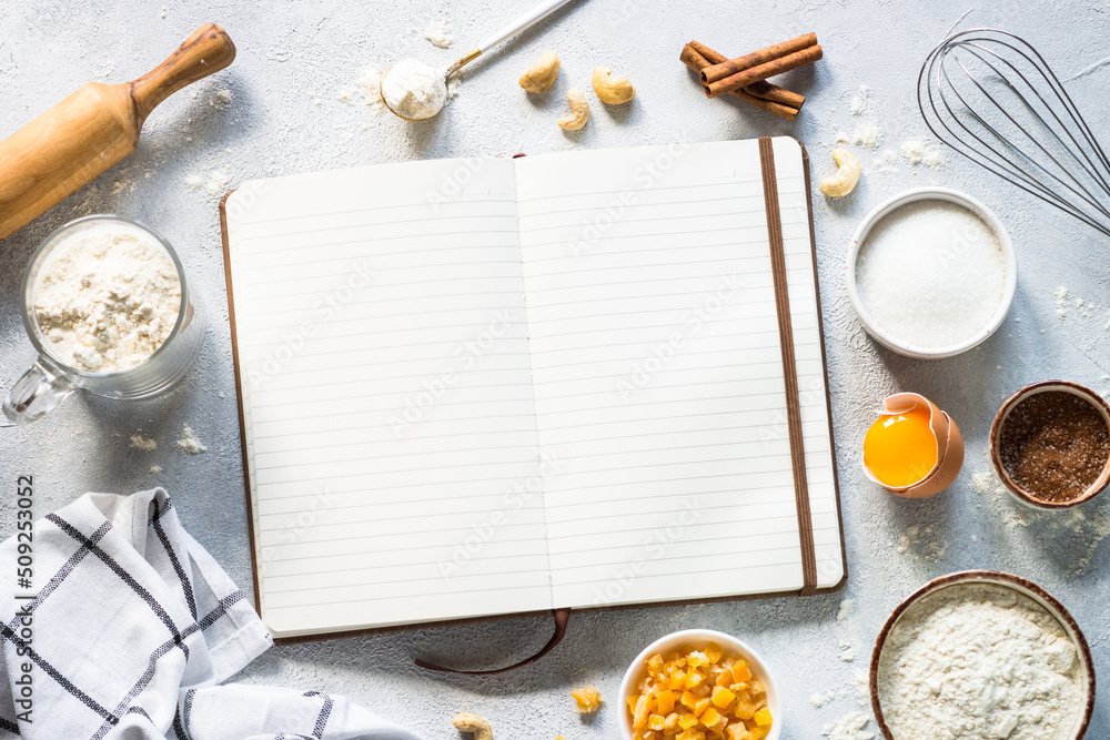 Baking background with cooking book and ingredients. Flour, sugar, eggs ...