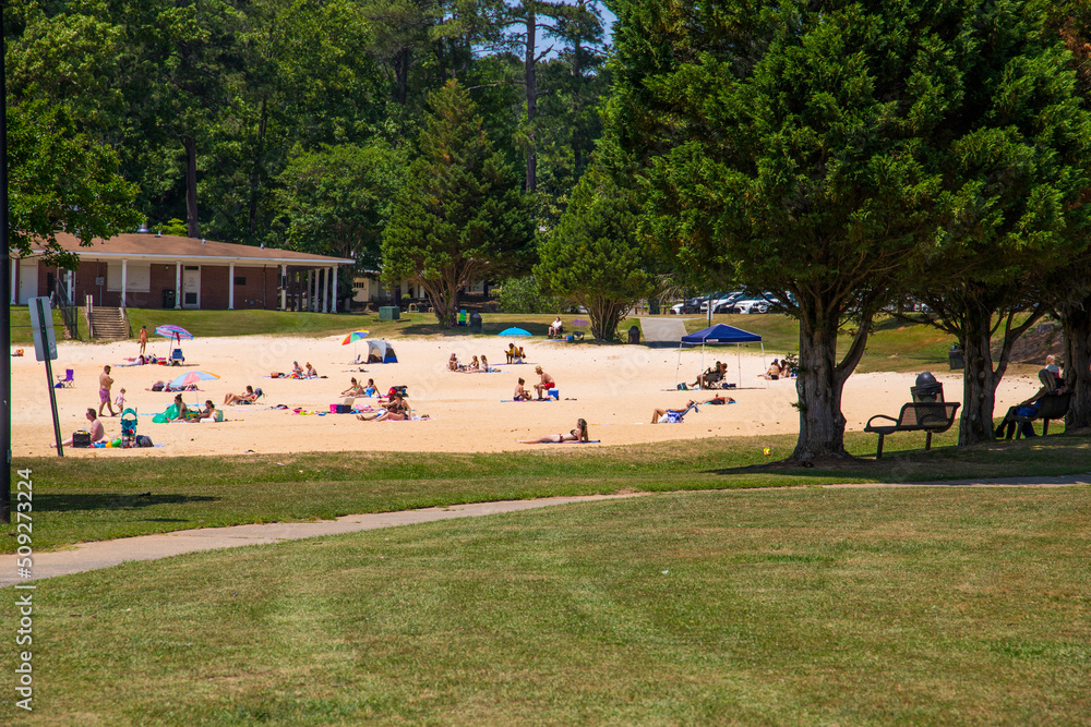 a gorgeous summer landscape at the beach with people sitting in the ...