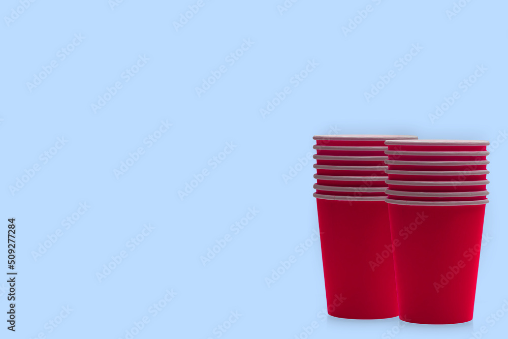 Bright red disposable paper drink cup isolated on pale blue background ...