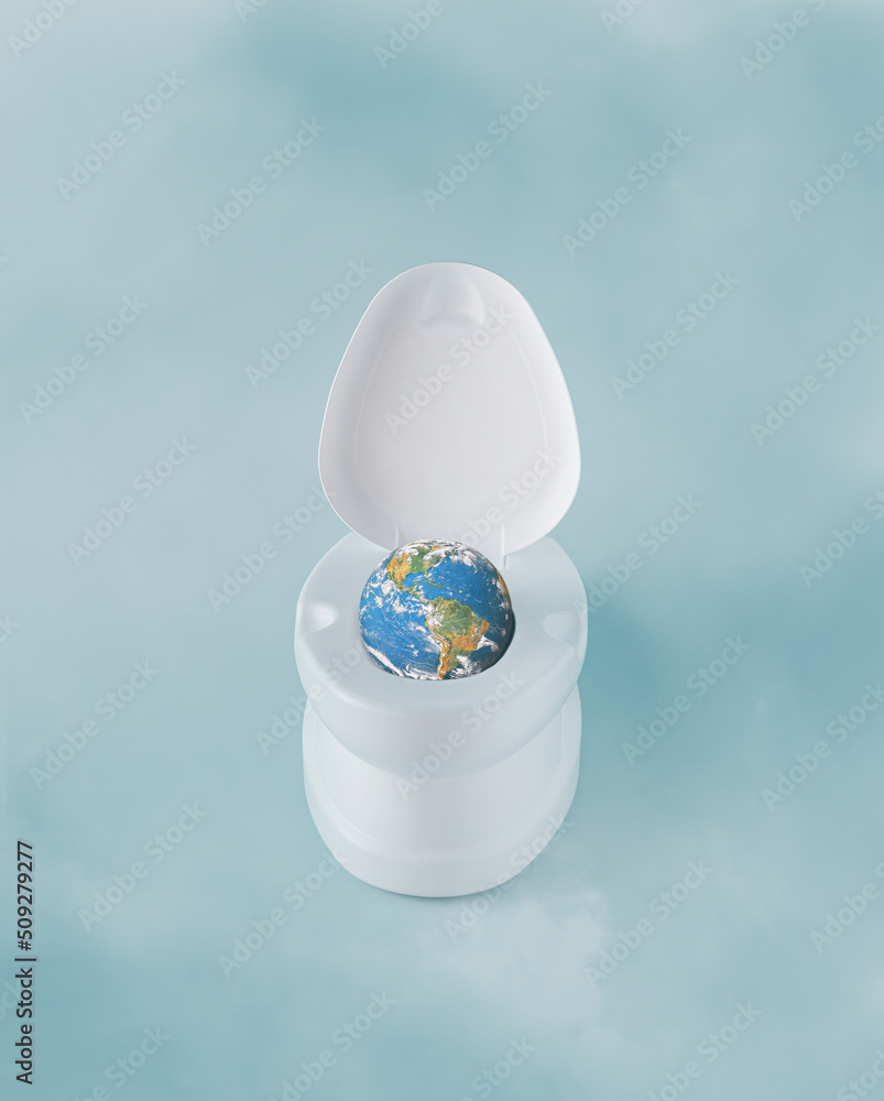 Planet Earth in white toilet on foggy, cloudy, pastel blue background ...