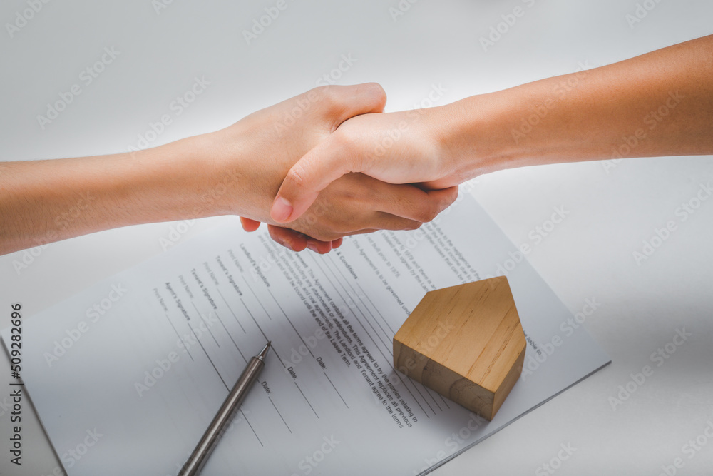 The landlord shake hand with the tenant after agreeing to the lease ...