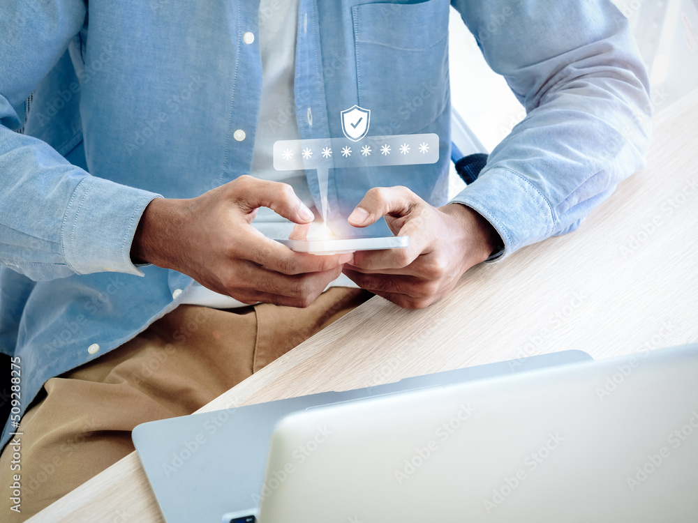 Two factor authentication concept. Virtual safety shield icon while access on phone with laptop ...