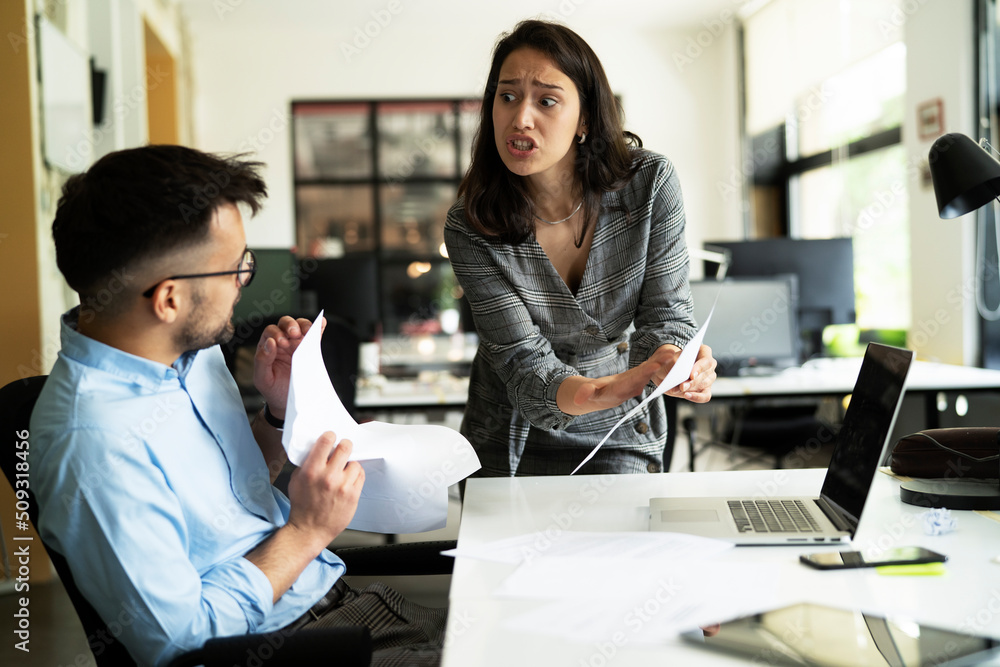 Colleagues arguing in office. Angry businesswoman yelling at her ...