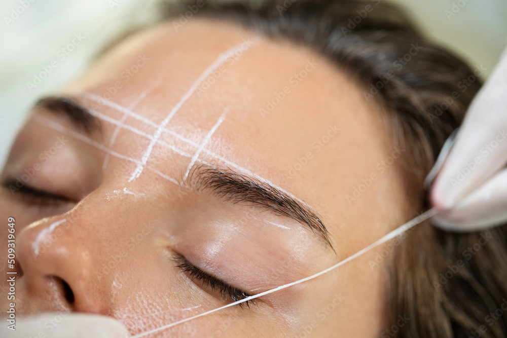 Woman during professional eyebrow mapping procedure Stock Photo | Adobe ...