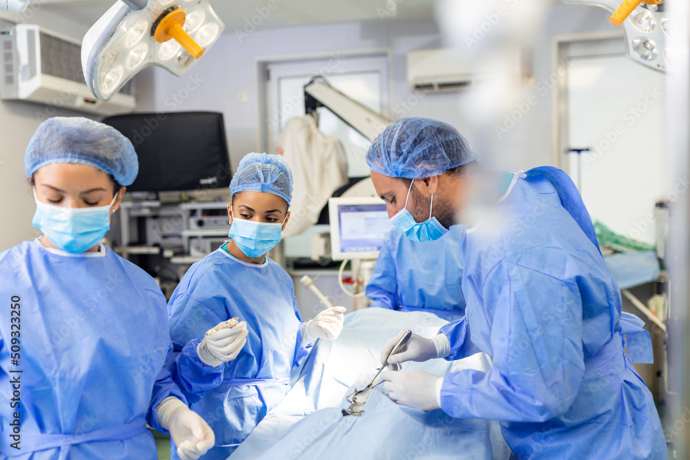 Medical team of surgeons in hospital doing minimal invasive surgical ...