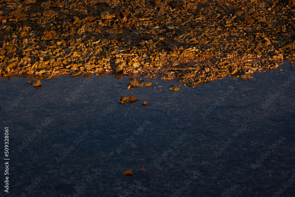 Abstract background - yellow mound of coral pebble and blue transparent ...