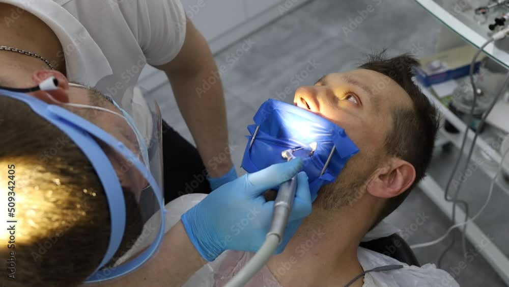real treatment. reportage. the dentist injects an anesthetic into the ...