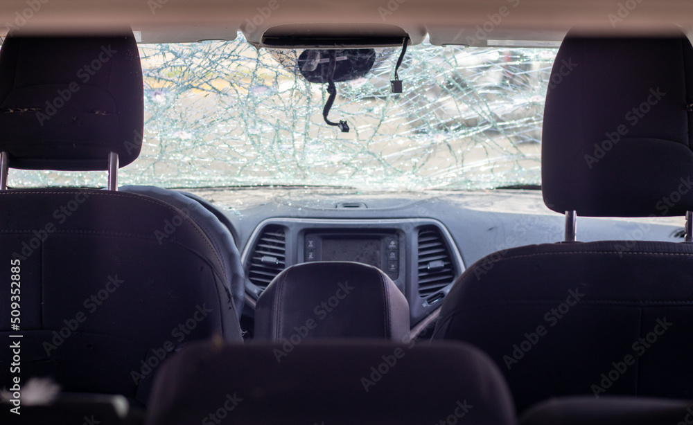 Damaged car window after an accident. Broken windshield as a result of ...