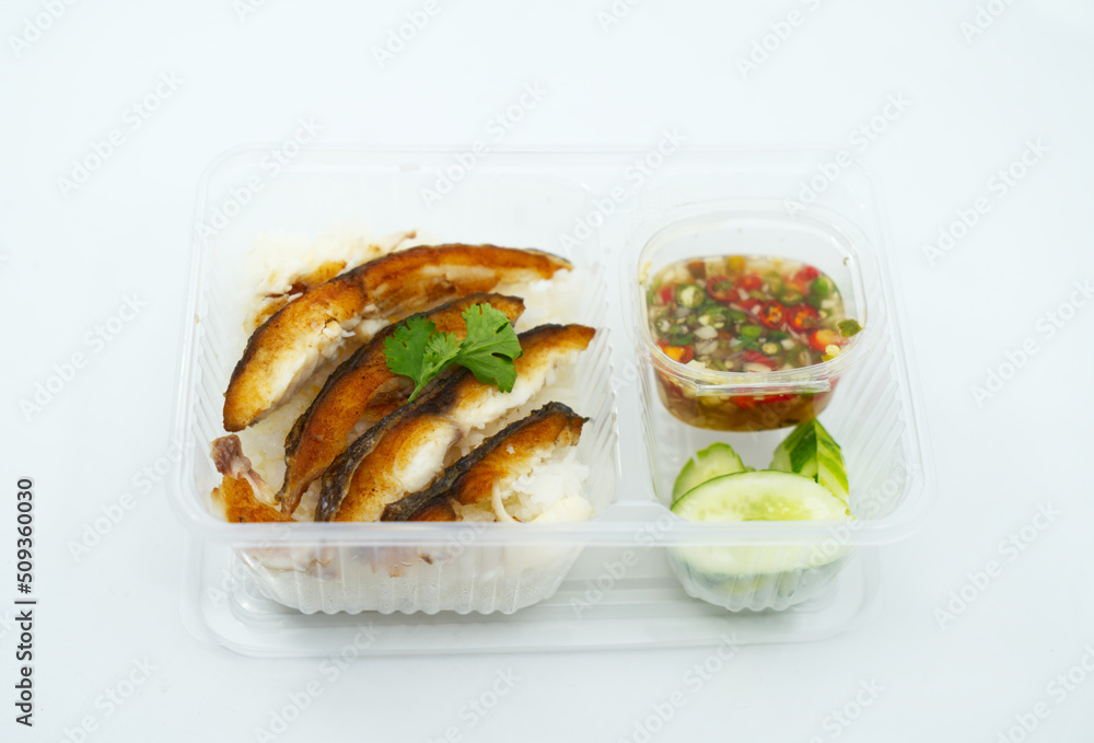 Deep-fried boneless fish over rice with mixed fish sauce, chili, and ...