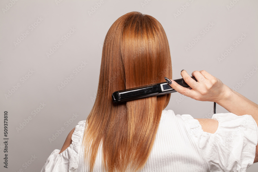 Hairdressing. Woman with beautiful long healthy hair using hair ...