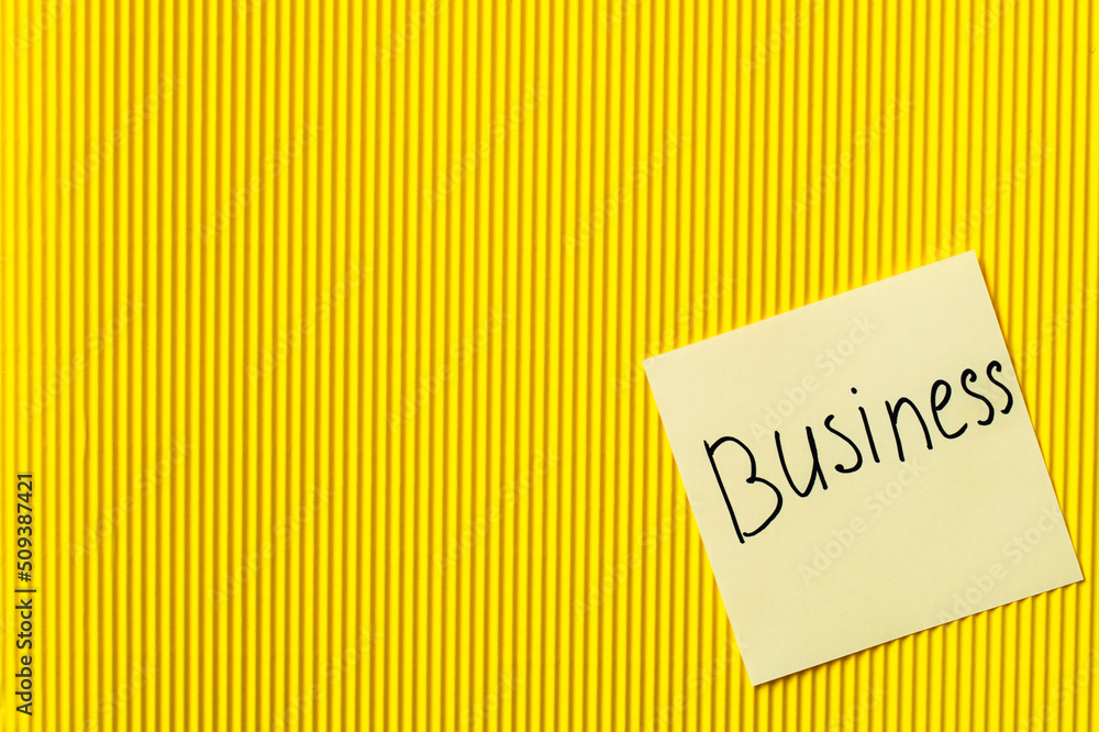 top view of paper with handwritten word business on yellow textured ...