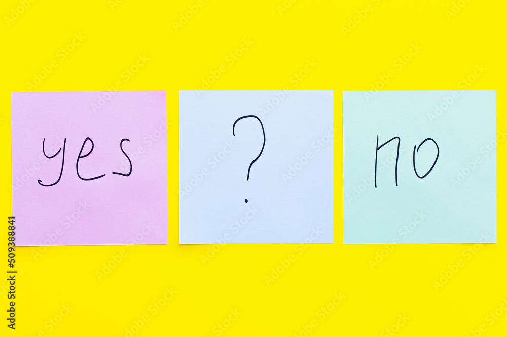 top view of sticky notes with question mark between yes and no words on ...