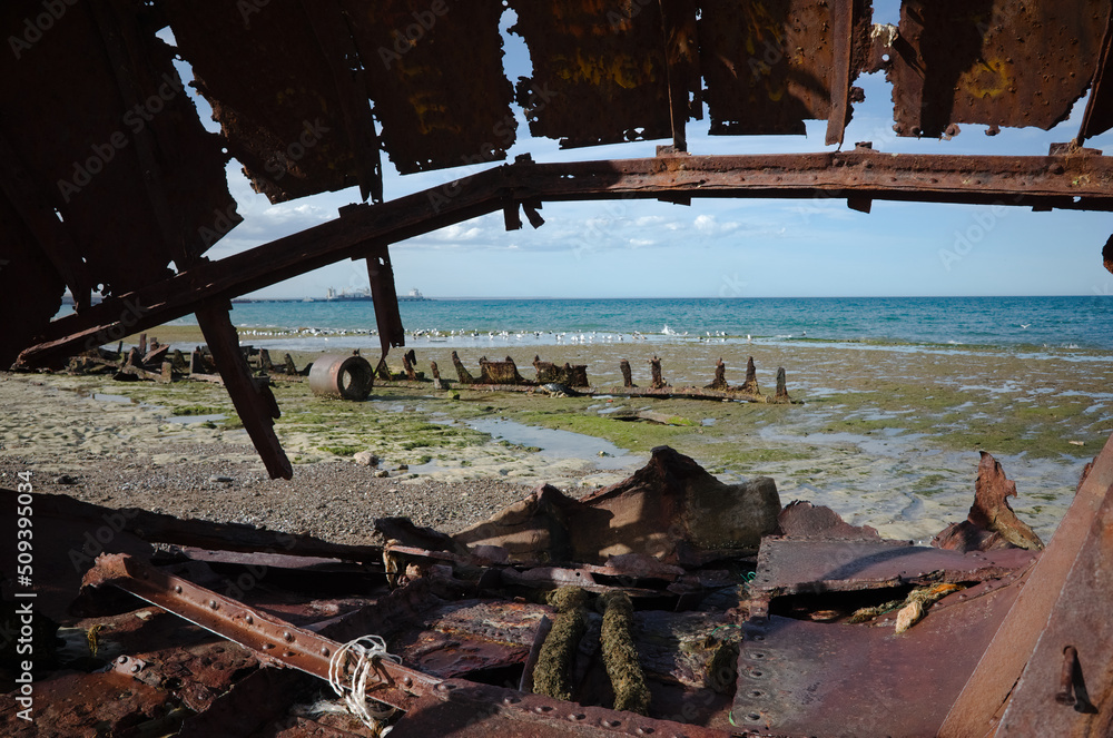 Shipwreck at coastline Atlantic Ocean. Rusty metal remains of hull of ...