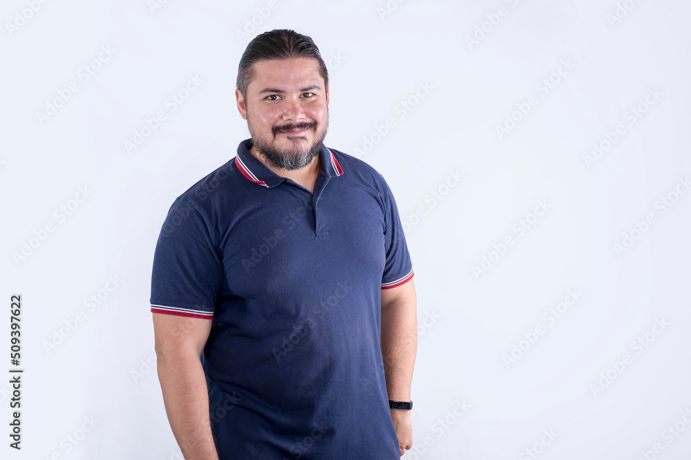 A bearded chubby man of mixed ancestry in his 30s. Wearing a blue polo ...