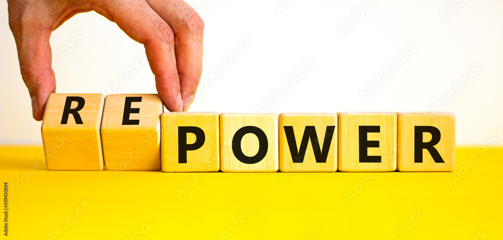 Power or repower symbol. Businessman turns wooden cubes and changes ...