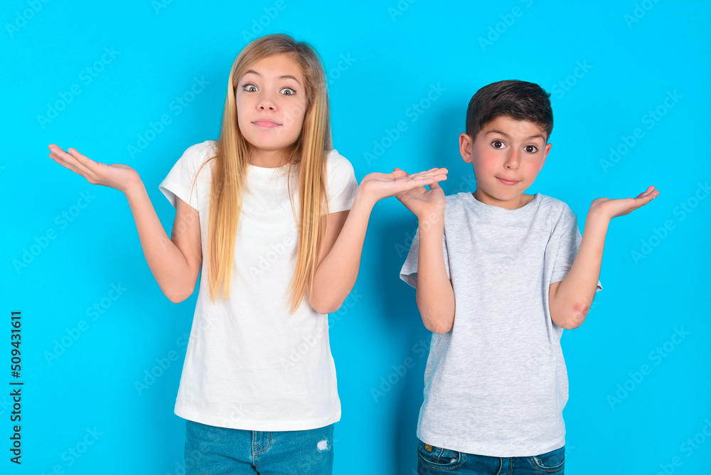 Maybe yes or no. Doubtful two kids boy and girl standing over blue ...