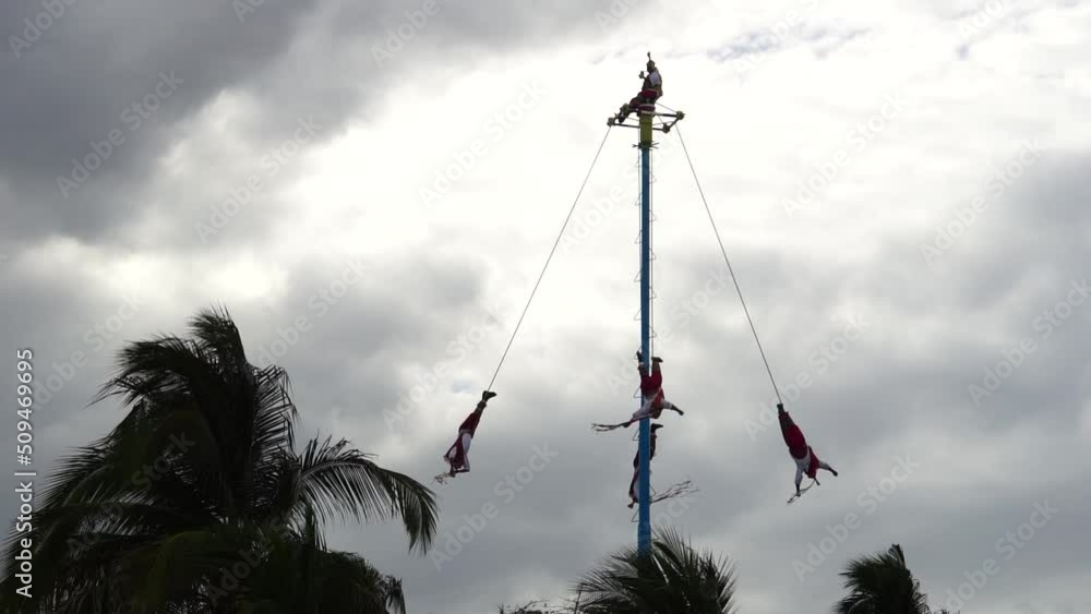 Mayan persons in traditional costumes perform the volador ritual dance ...