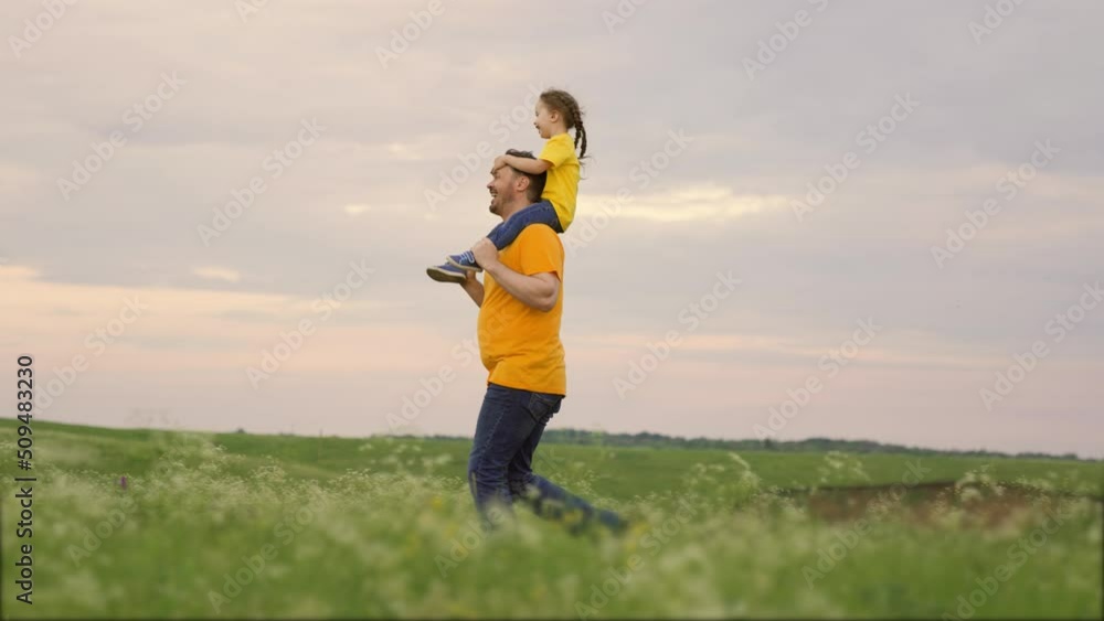 Happy family running in park. Kid daughter plays superhero with father ...