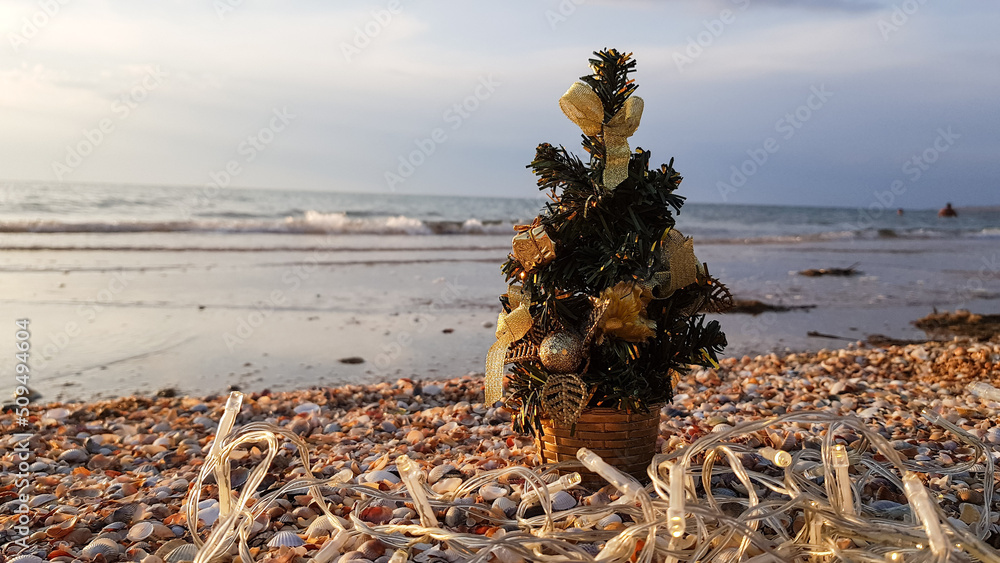Christmas tree made of sea pebbles on the background of the sea. a red ...