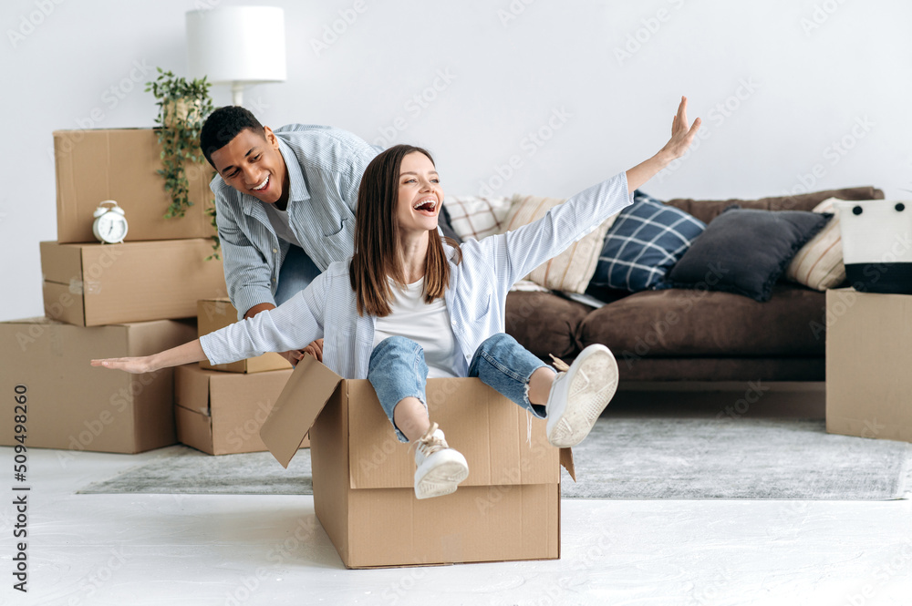 New home, relocation. Happy mixed race young family couple, bought ...