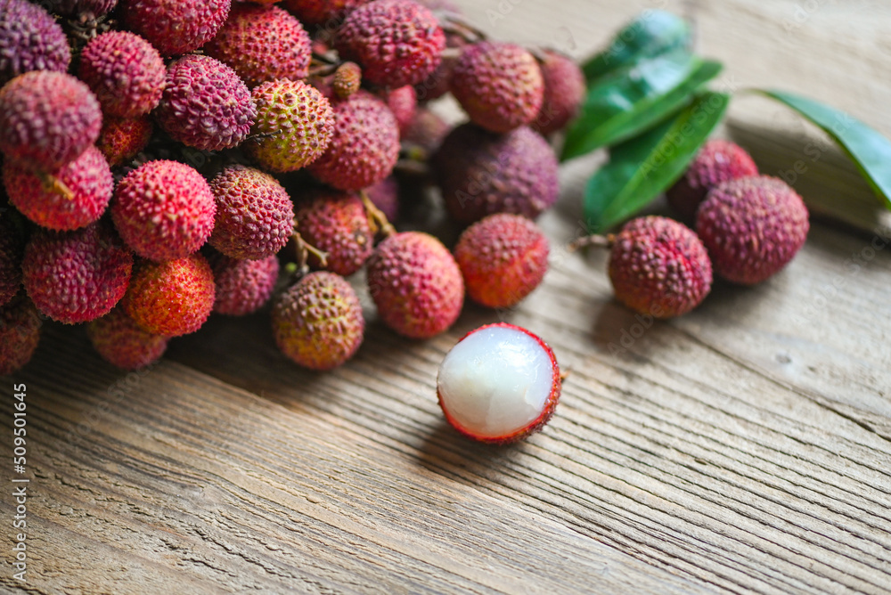 Lychee fruit on wooden background with green leaf , fresh ripe lychee ...