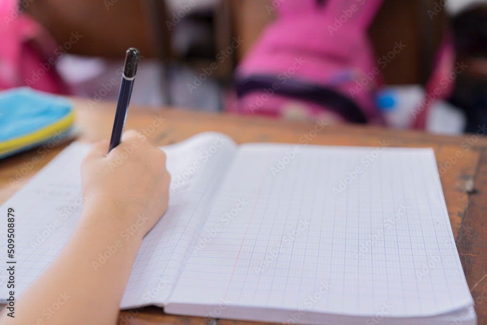 Students writing and reading exam answer sheets exercises in classroom ...