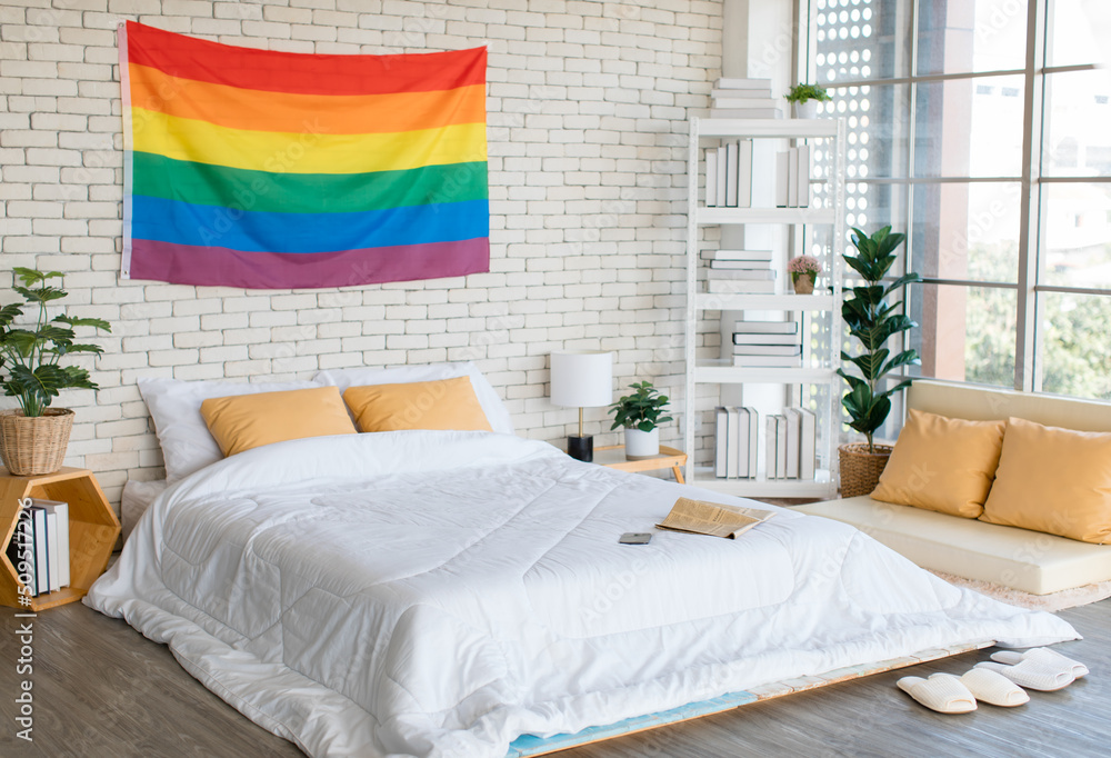 Large rainbow colorful gay pride flag hanging on brick wall pattern ...