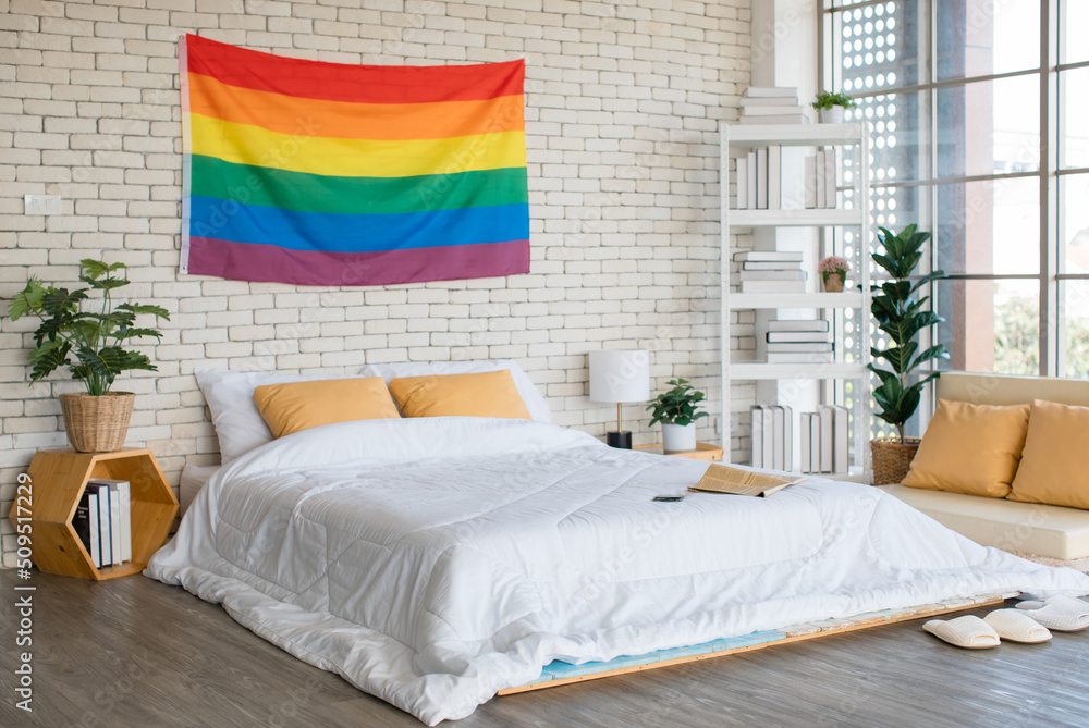 Large rainbow colorful gay pride flag hanging on brick wall pattern ...